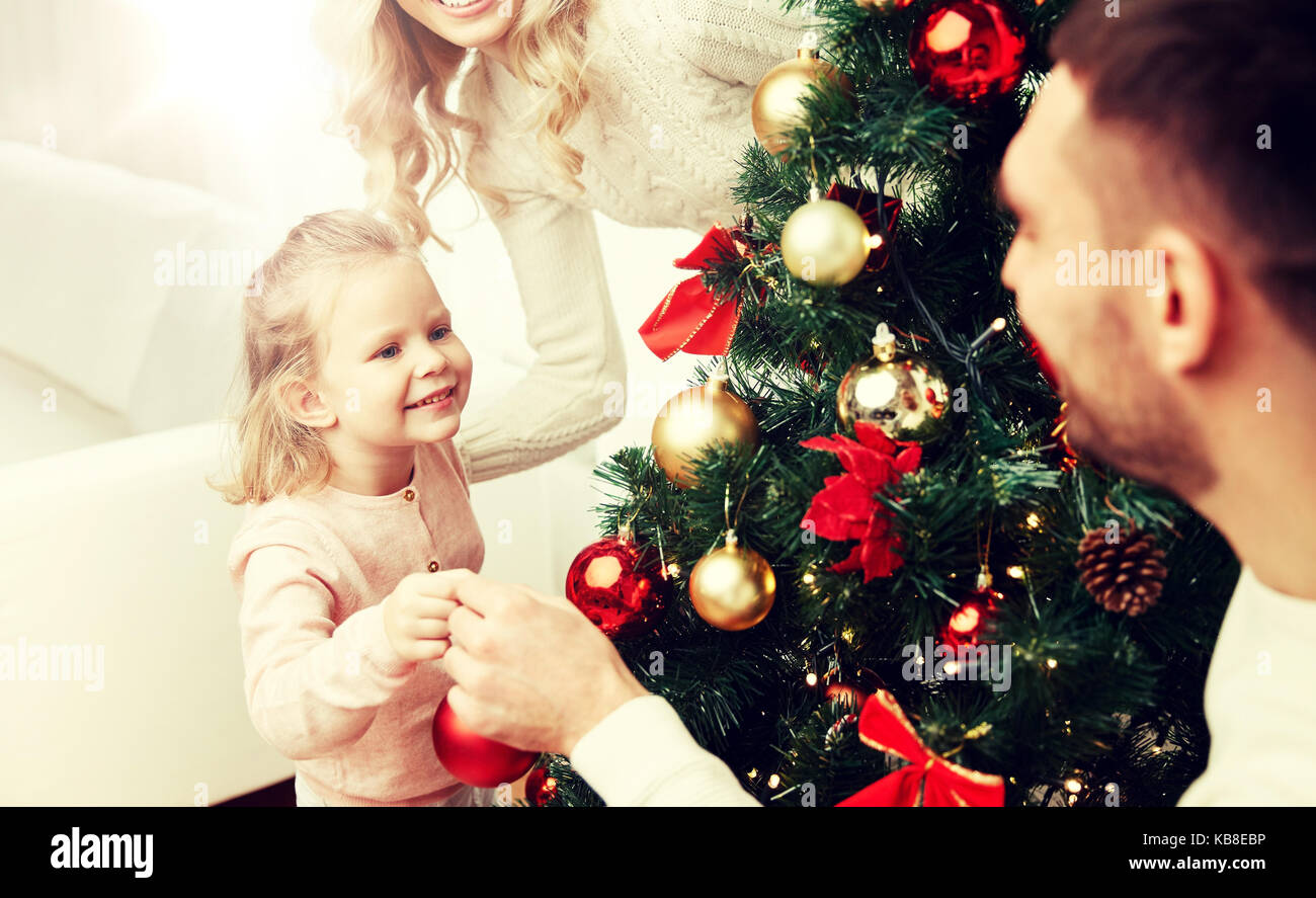 happy family decorating christmas tree at home Stock Photo - Alamy
