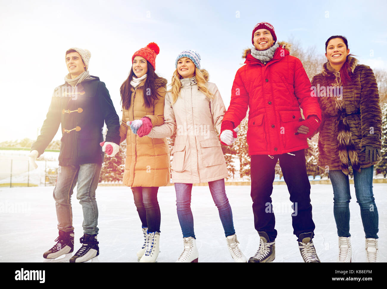 happy friends ice skating on rink outdoors Stock Photo - Alamy
