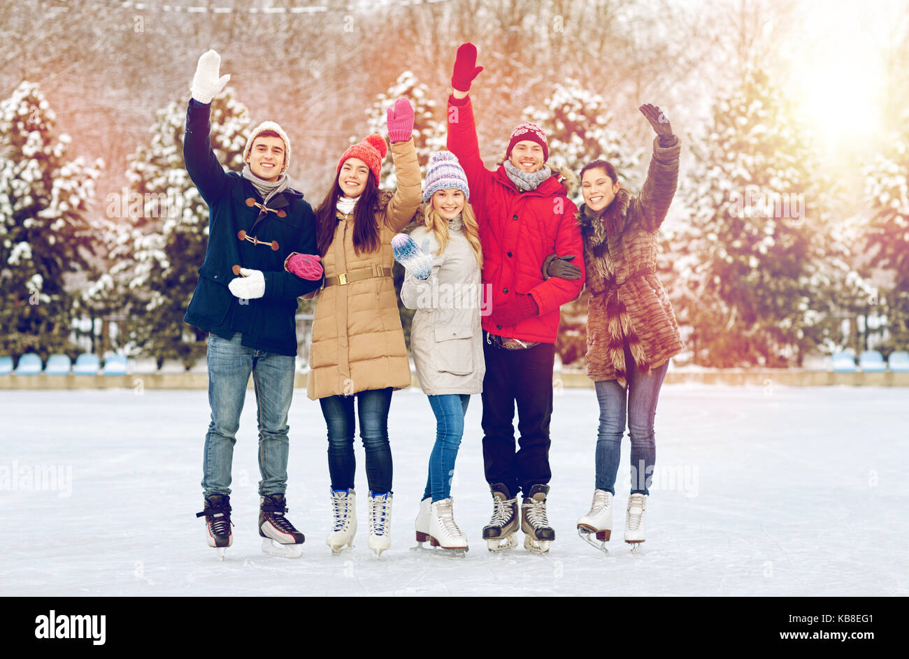 happy friends ice skating on rink outdoors Stock Photo - Alamy