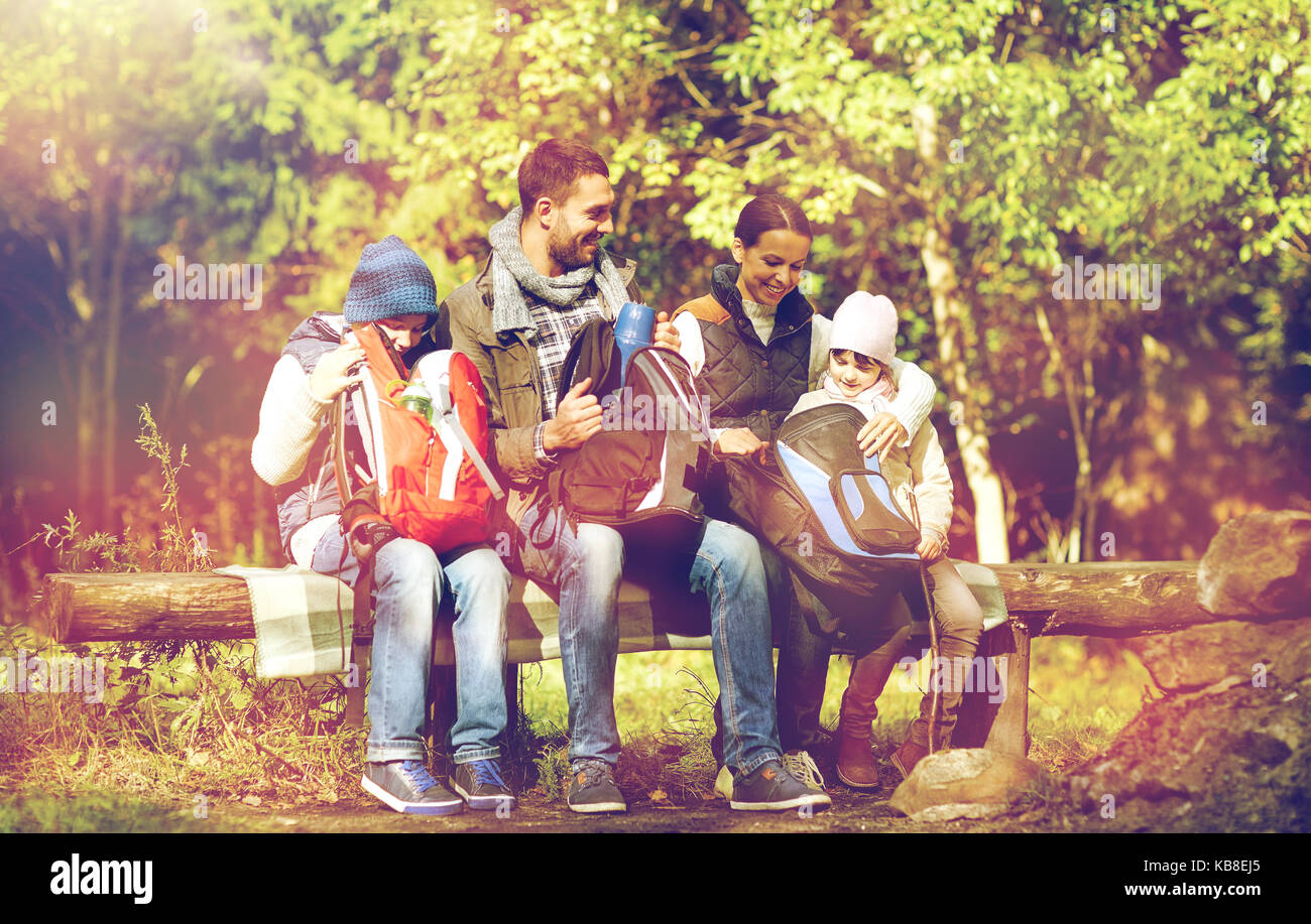 happy family with backpacks and thermos at camp Stock Photo - Alamy