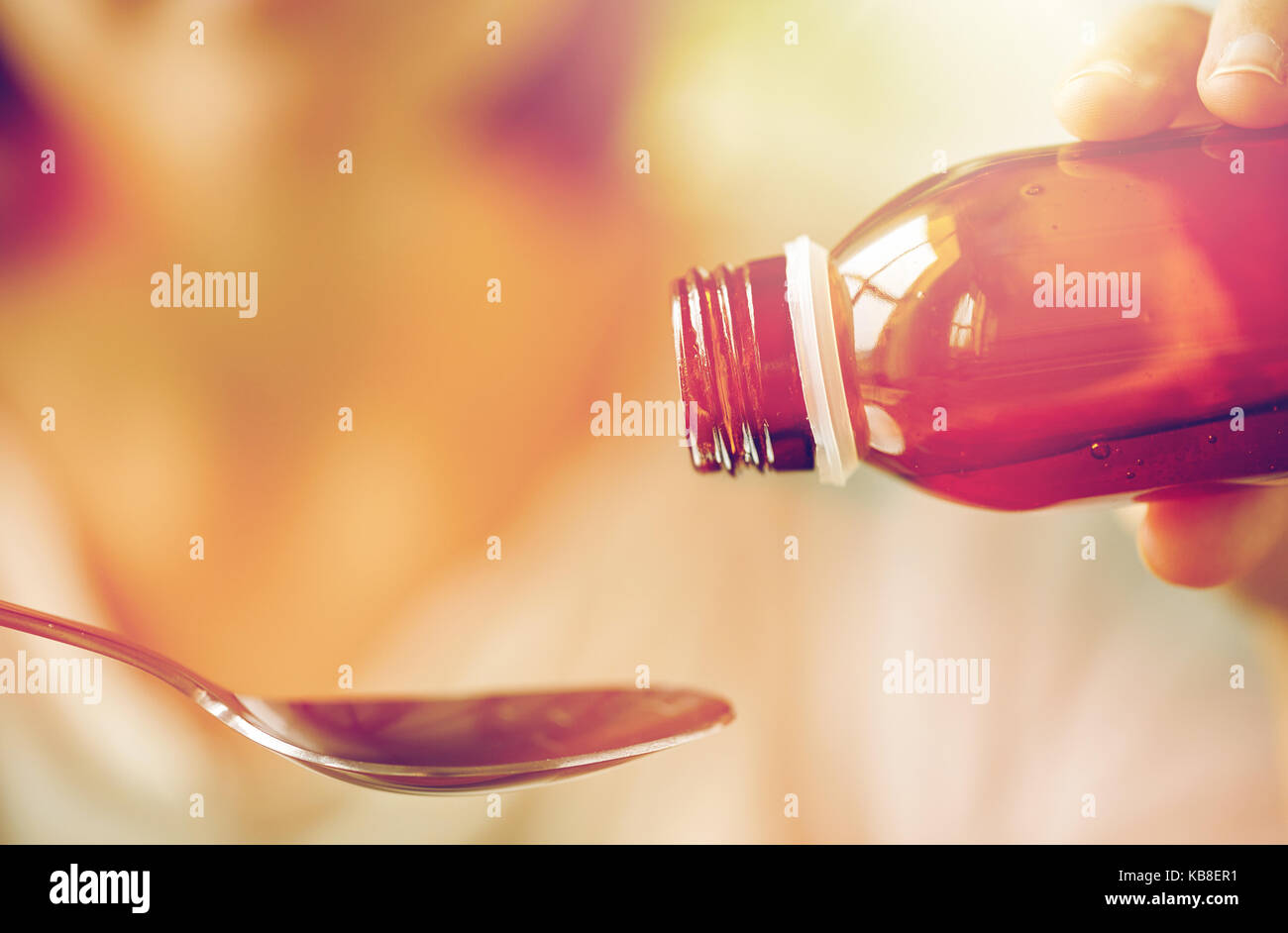 woman pouring medication from bottle to spoon Stock Photo - Alamy