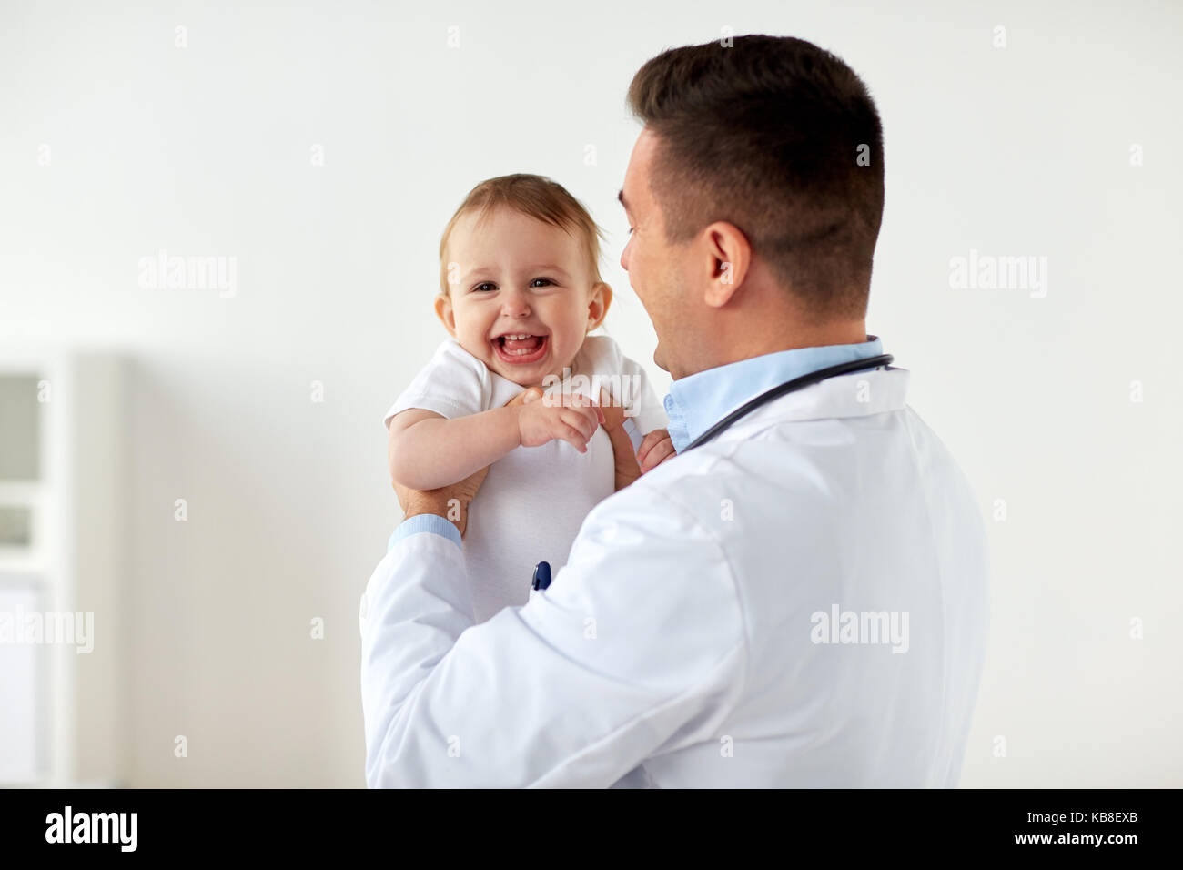 happy doctor or pediatrician with baby at clinic Stock Photo - Alamy