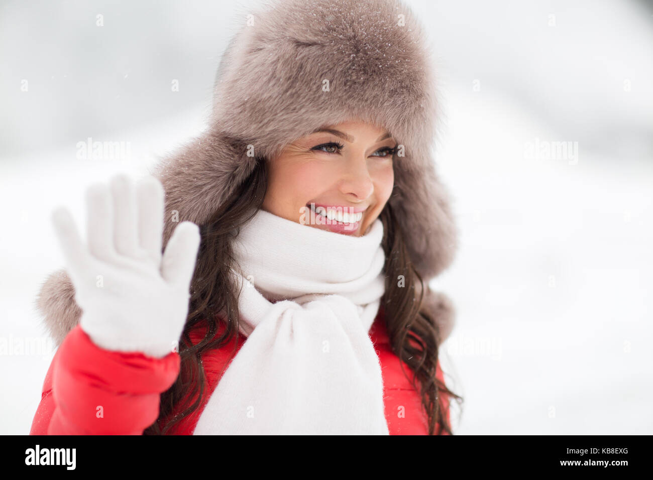 happy woman in winter fur hat waving hand outdoors Stock Photo - Alamy