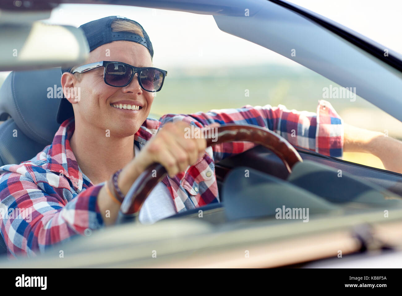 happy young man in shades driving convertible car Stock Photo - Alamy