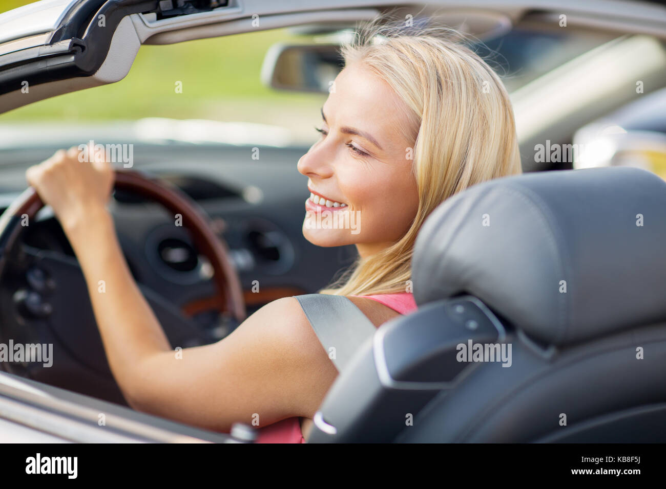 happy young woman driving convertible car Stock Photo - Alamy
