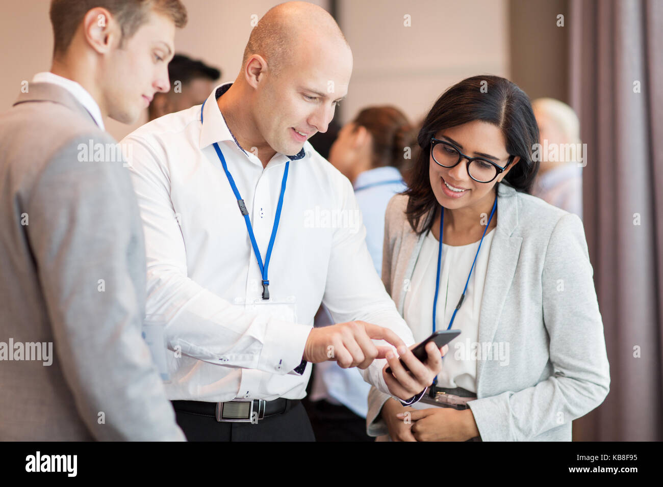 couple with smartphone at business conference Stock Photo - Alamy