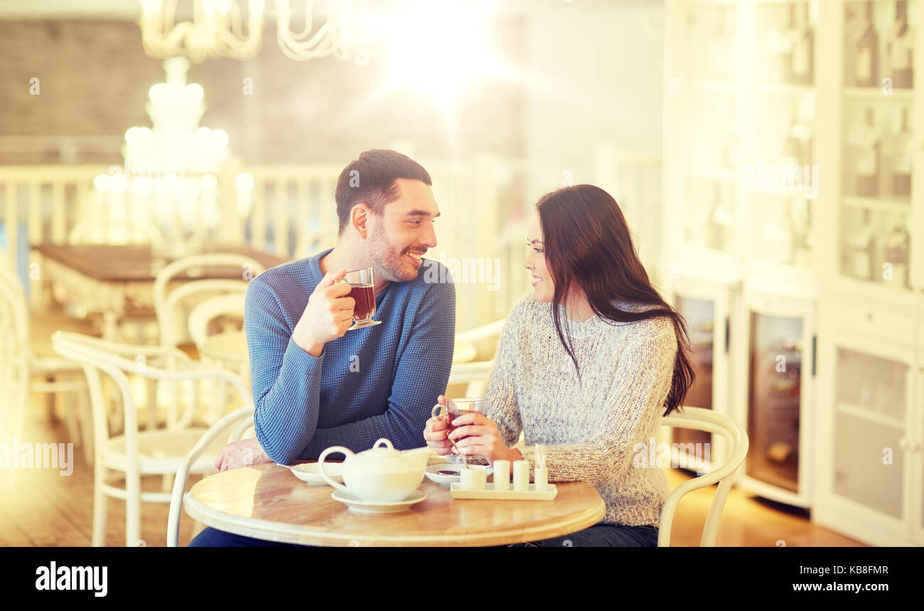 happy couple drinking tea at cafe Stock Photo - Alamy
