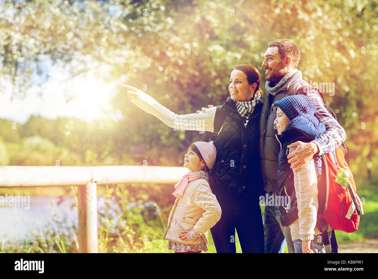 happy family with backpacks hiking Stock Photo - Alamy