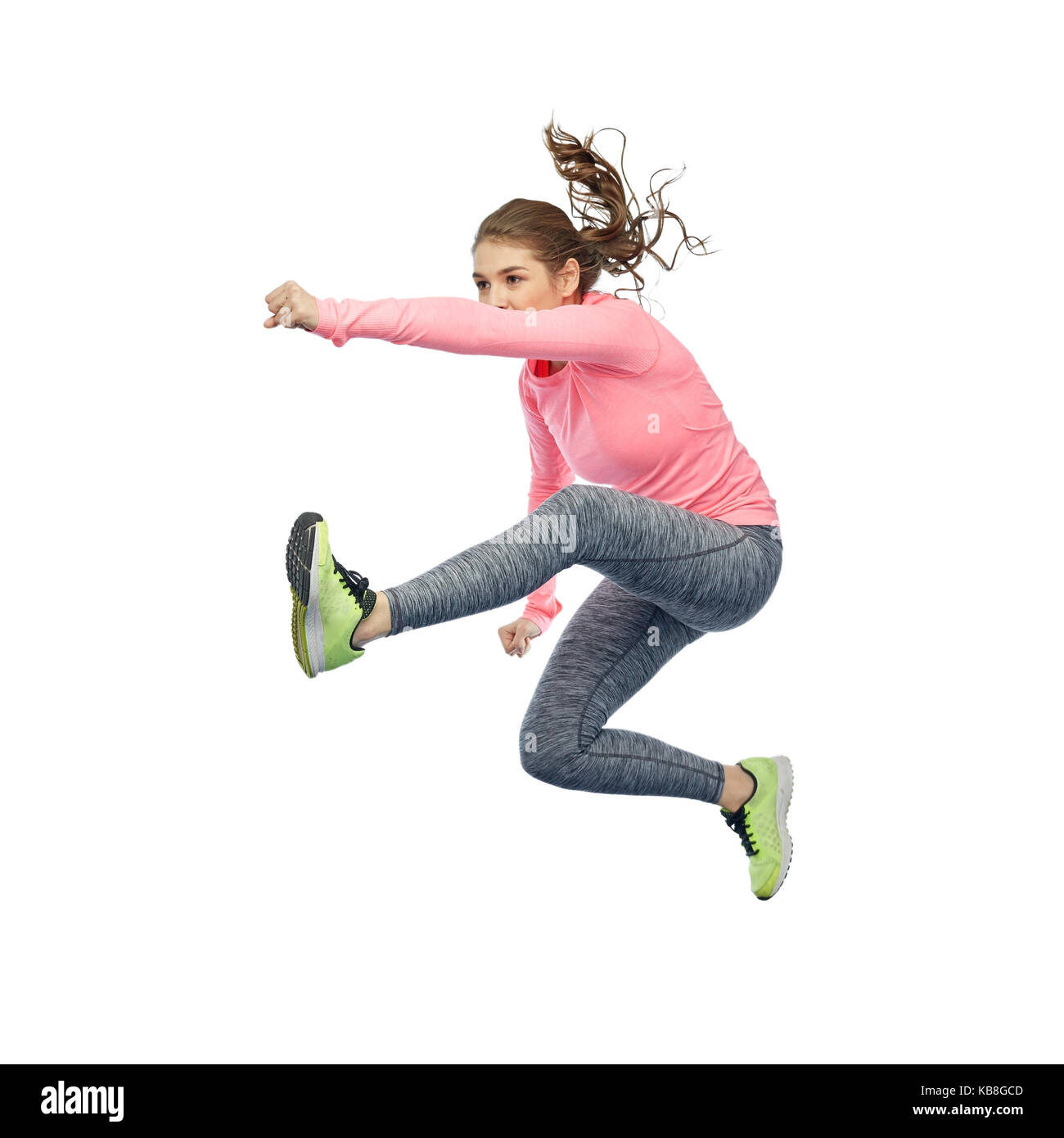 happy sporty young woman jumping in fighting pose Stock Photo - Alamy