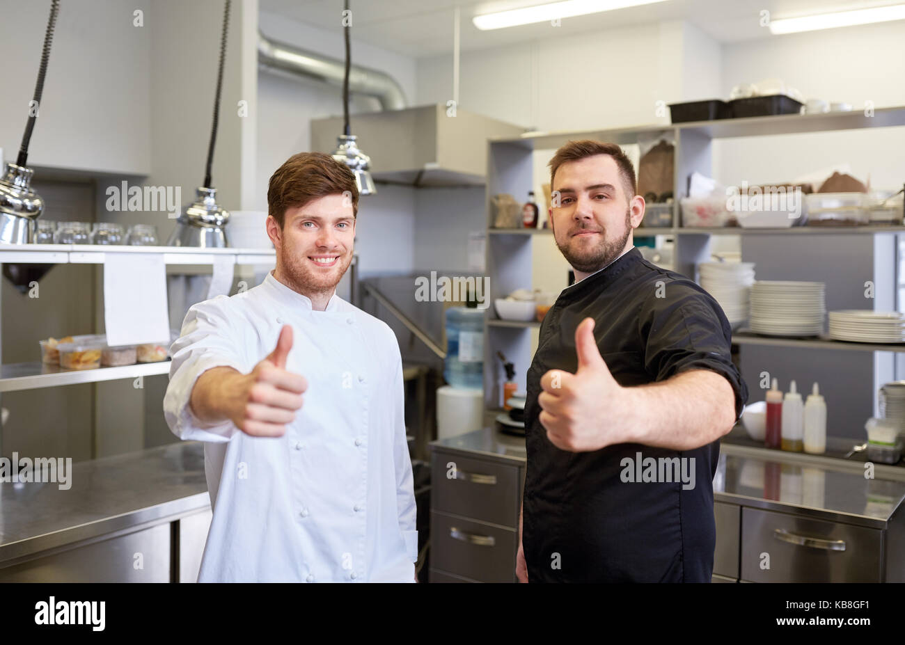 chefs at restaurant kitchen showing thumbs up Stock Photo - Alamy