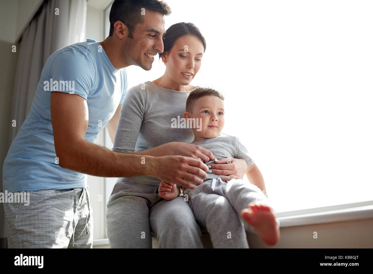 happy family at window Stock Photo - Alamy