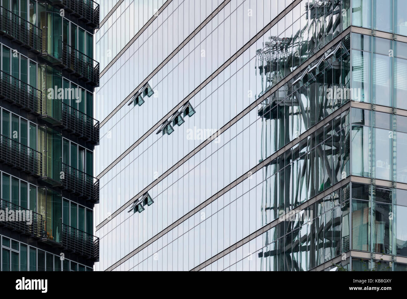 Modern Glass building in Berlin, with odd shapes of some windows open ...