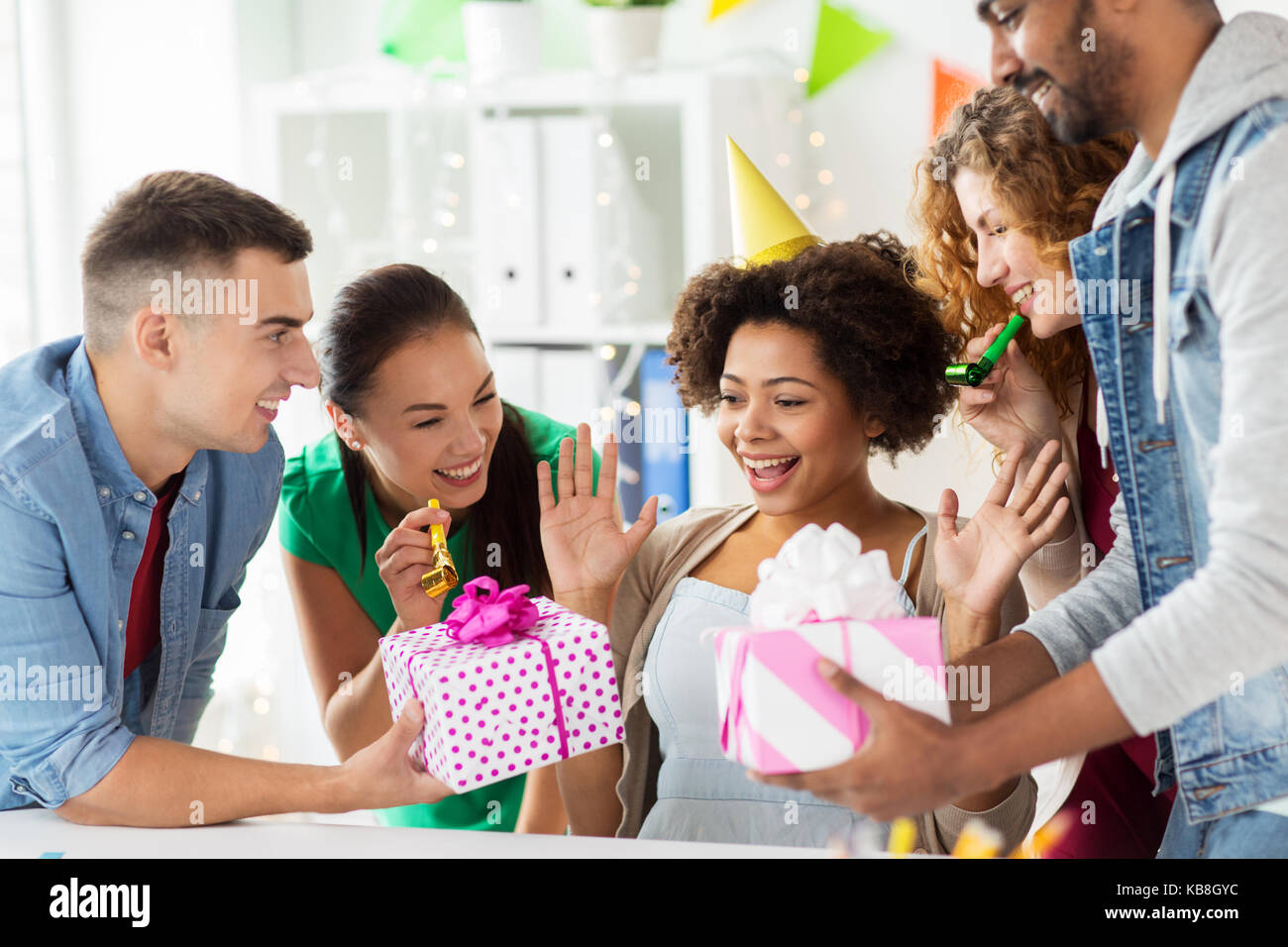 team greeting colleague at office birthday party Stock Photo - Alamy
