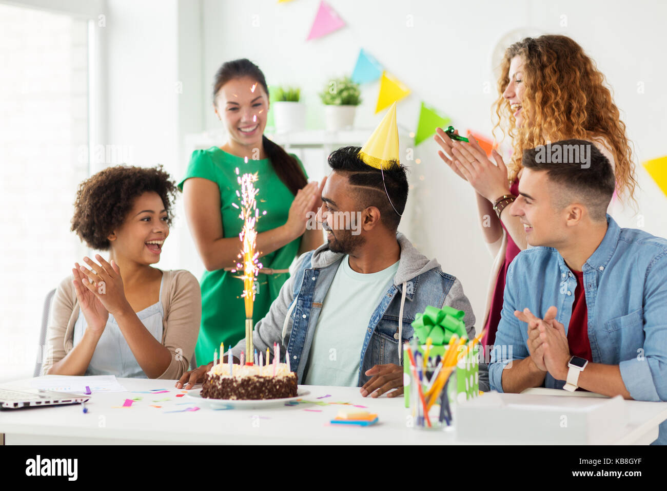 team greeting colleague at office birthday party Stock Photo - Alamy