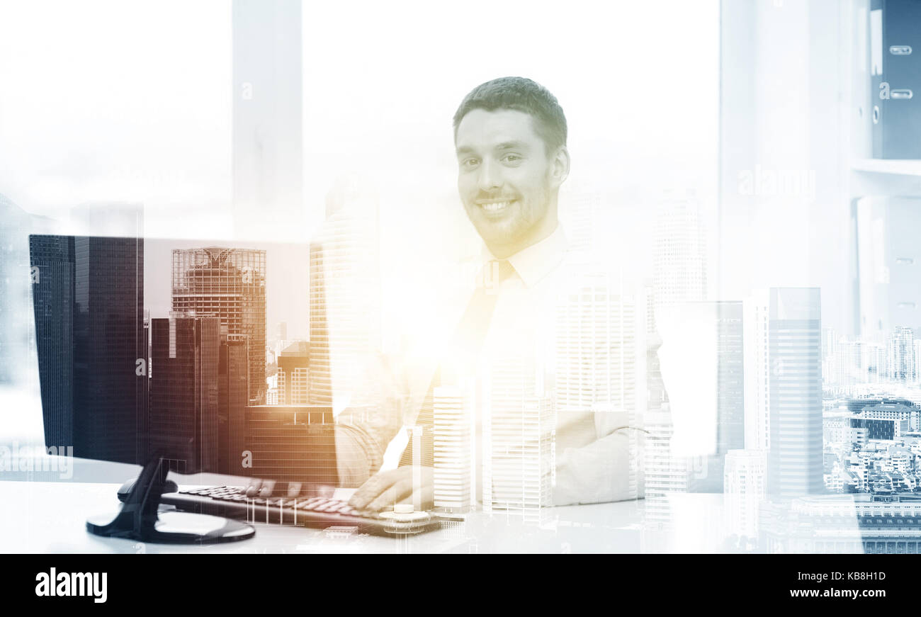 smiling businessman with computer at office Stock Photo - Alamy