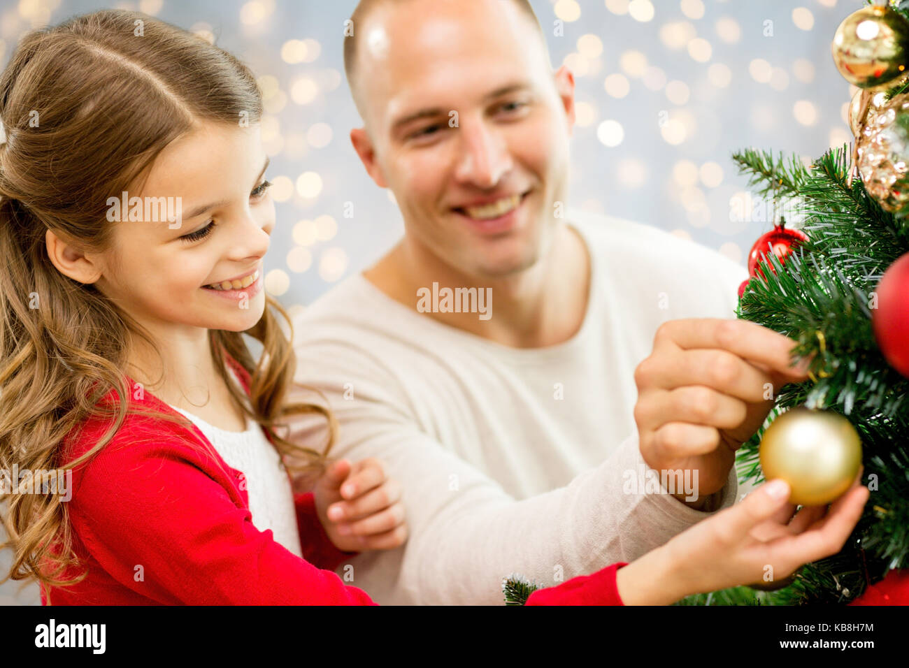 father and daughter decorating christmas tree Stock Photo - Alamy