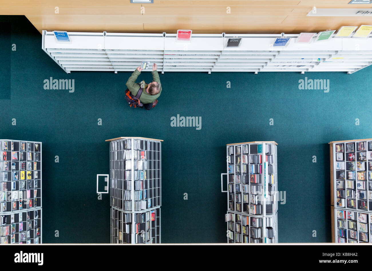 Plan view of library shelving with a man choosing a book Stock Photo ...