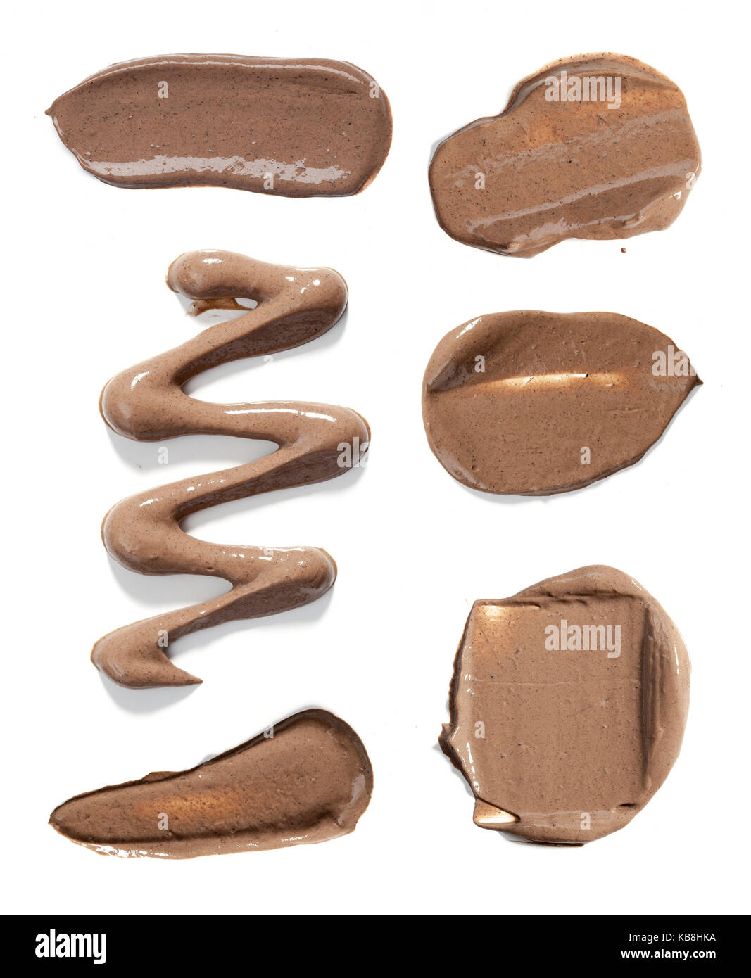 Collection of make up liquid foundation strokes on a white background ...
