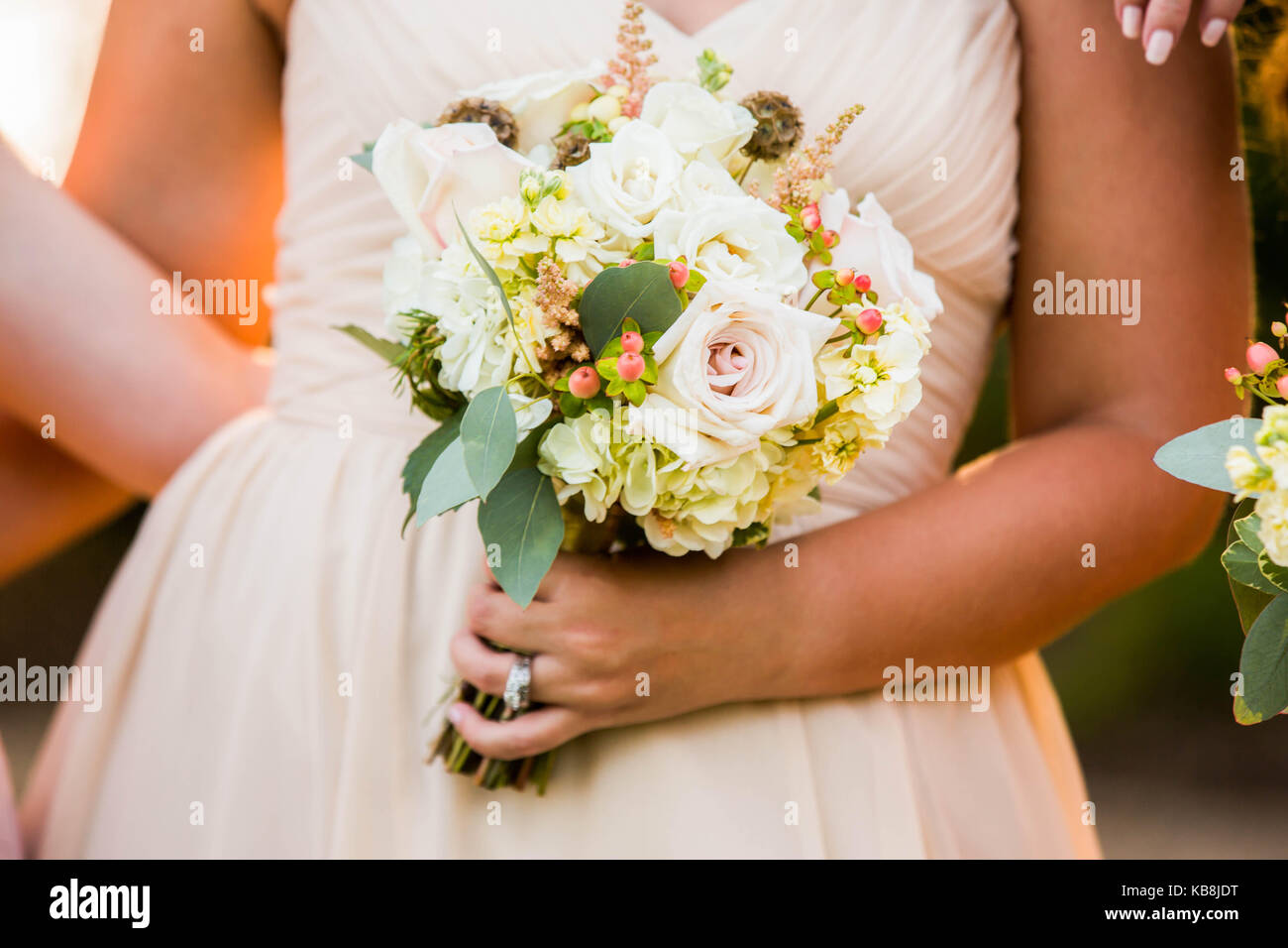 Bridesmaid holding a very well put together rustic pink, bouquet Stock ...
