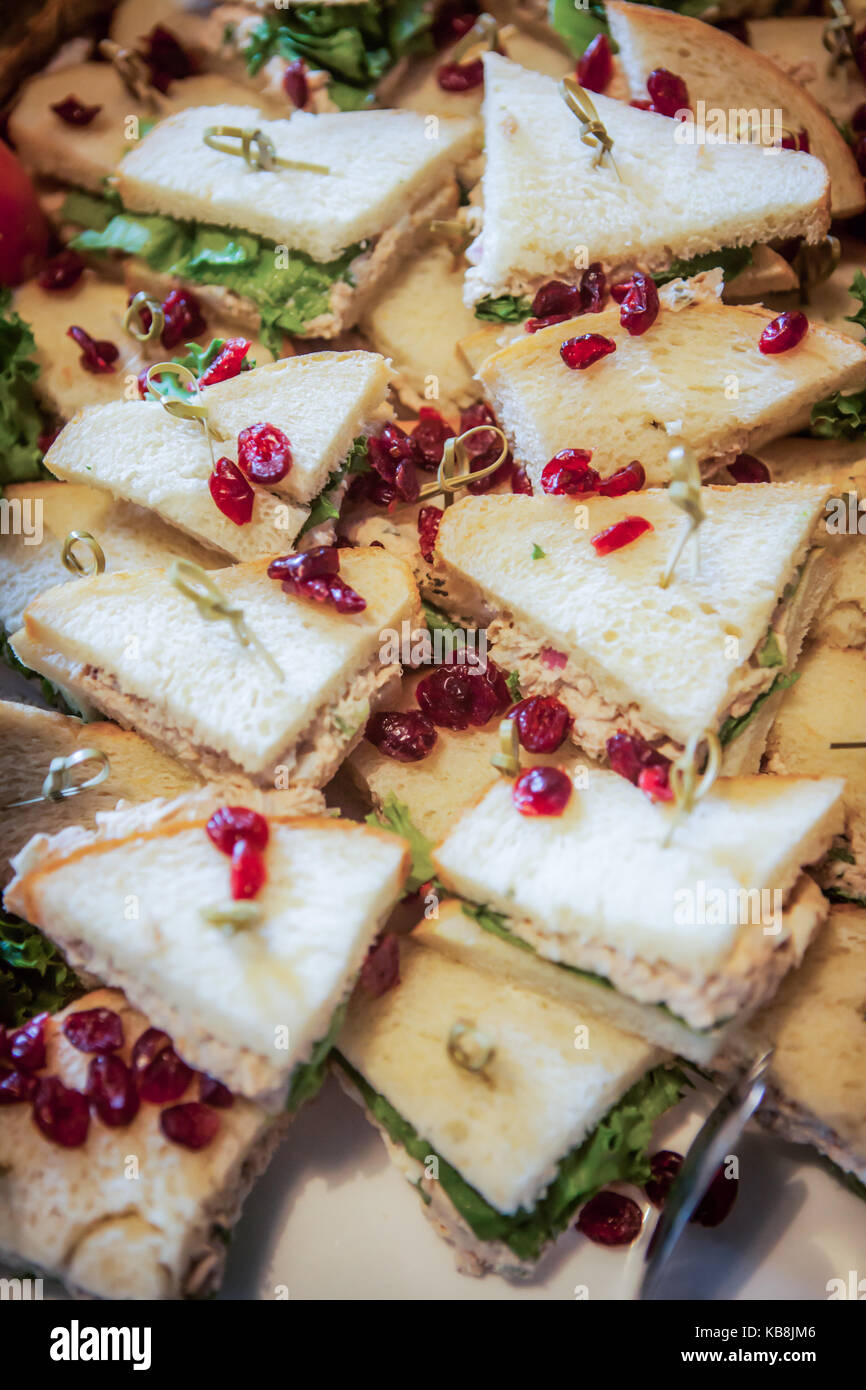 Sandwich triangles nicely laid out with beautiful cranberry garnish ...