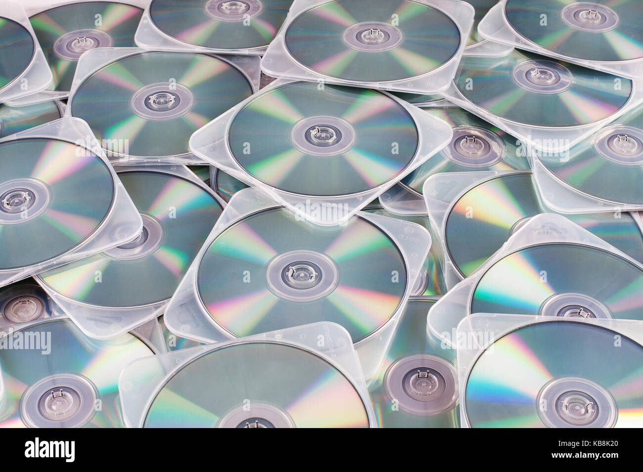 Reflective side of DVD in hard clear plastic cases strewn about ...