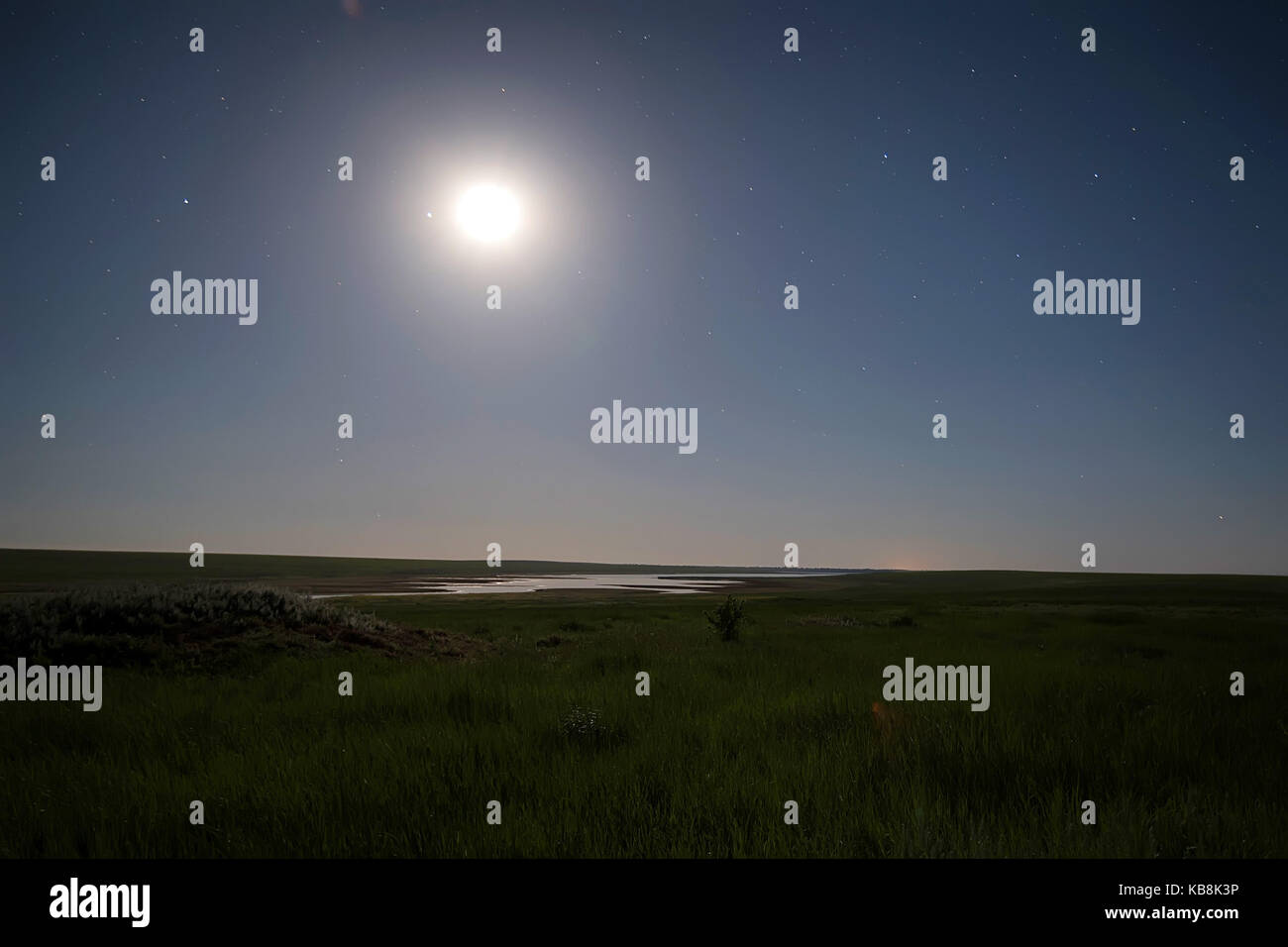 Night and the moon on a green field Stock Photo - Alamy