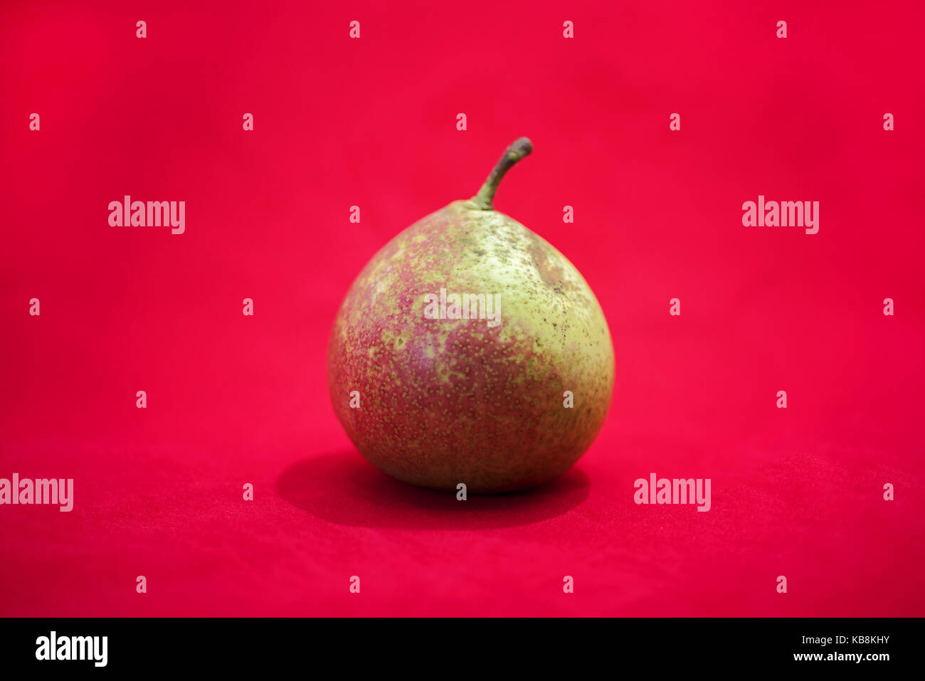 Big yellow Pear isolated on red background Stock Photo - Alamy