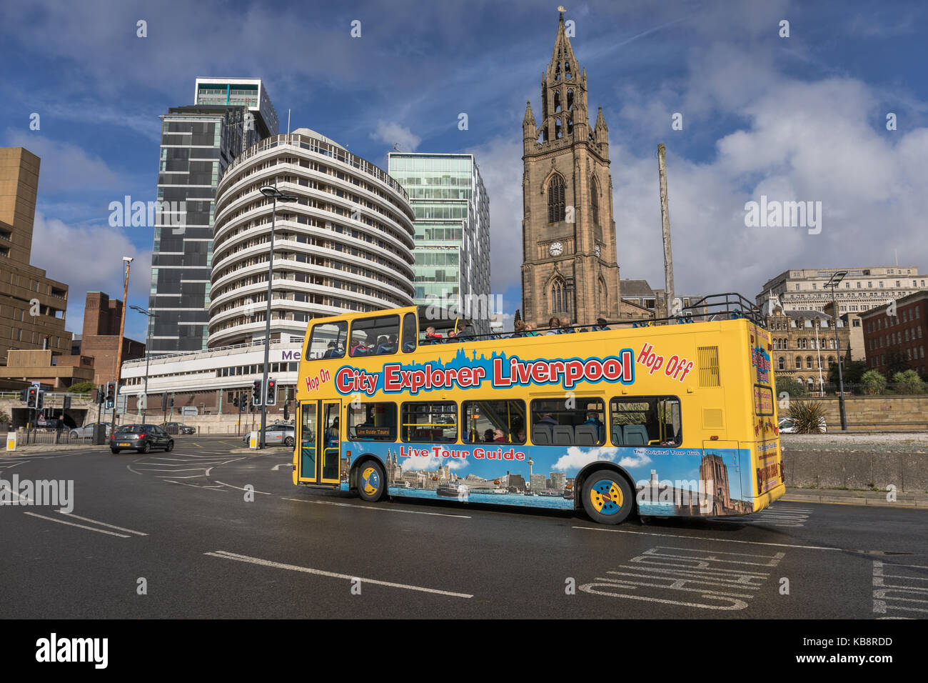 Double-decker sightseeing hop-on hop-off bus in front of the Mercure ...