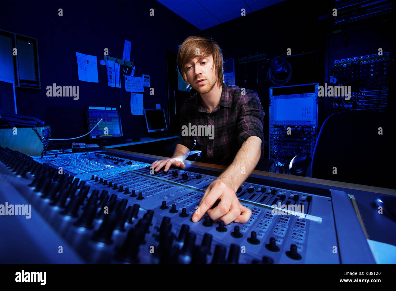 Man using a sound mixing desk in a recording studio Stock Photo - Alamy