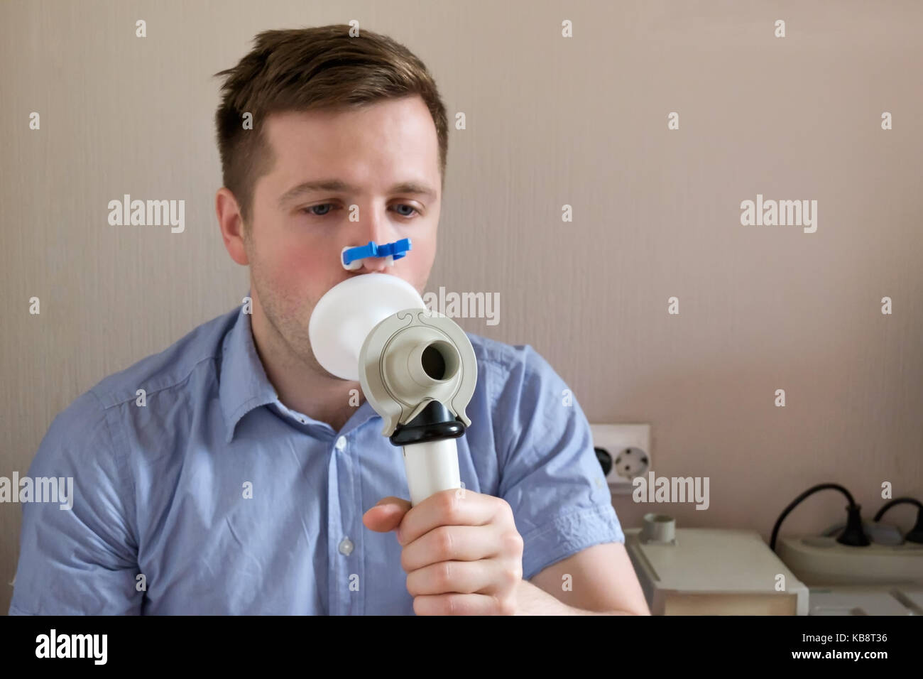 Young man testing breathing function by spirometry Stock Photo - Alamy