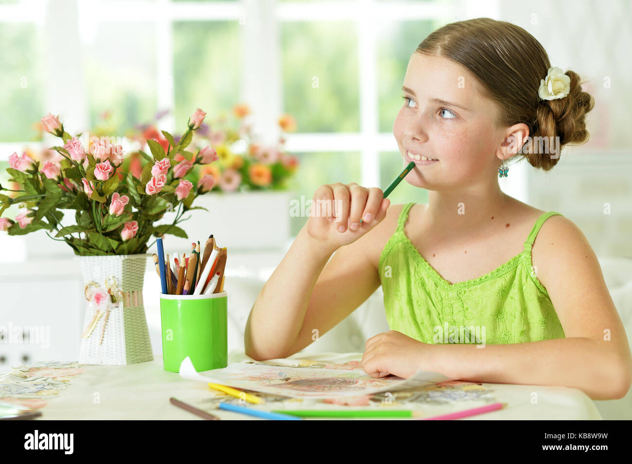 Cute girl drawing with pencils Stock Photo - Alamy