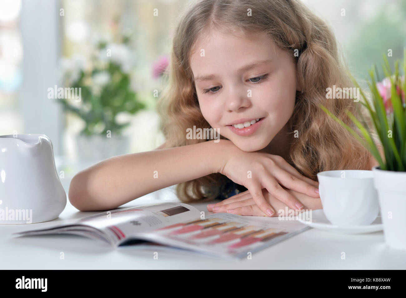little girl reading magazine Stock Photo - Alamy