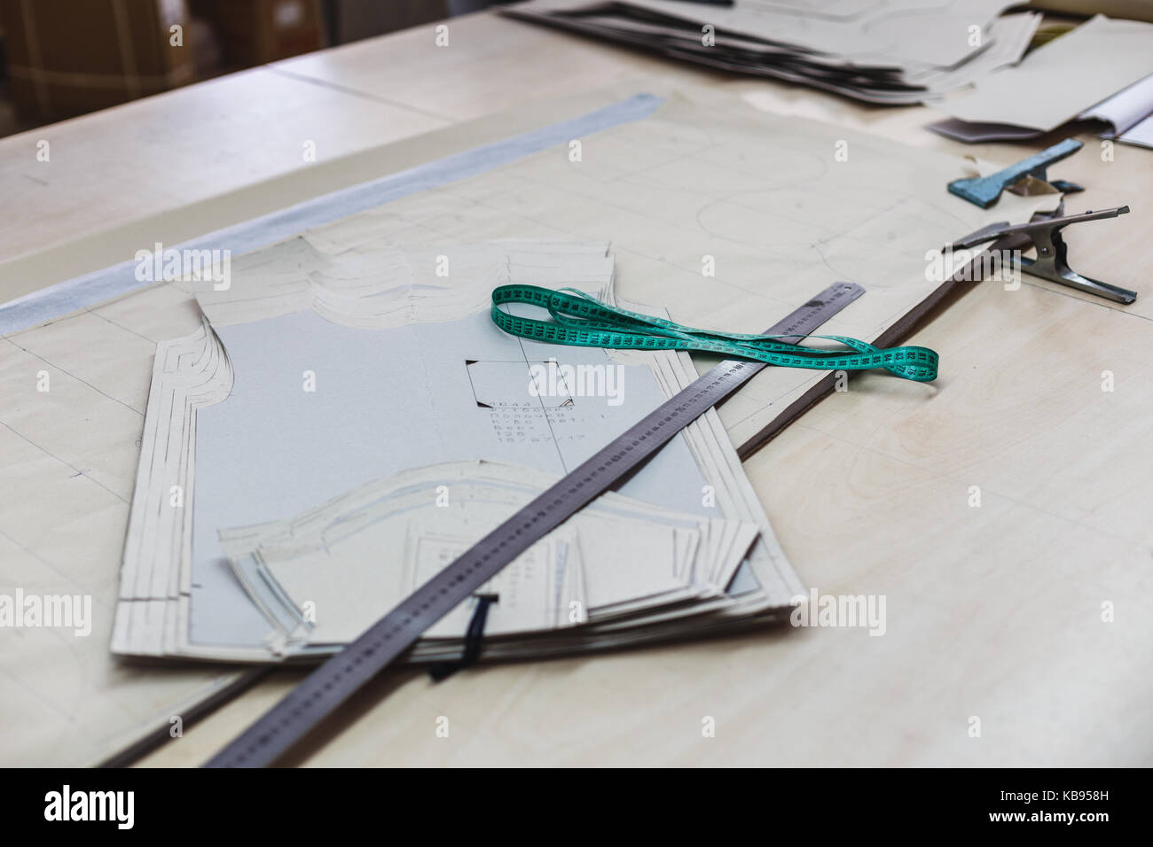 Still life photo of a clothes pattern template with ruler, tape measure ...