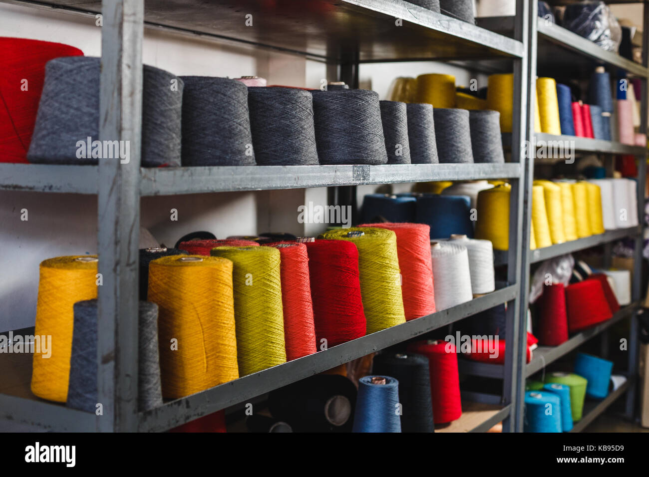 Shelf with large coils of thread. Professional equipment for tailoring ...