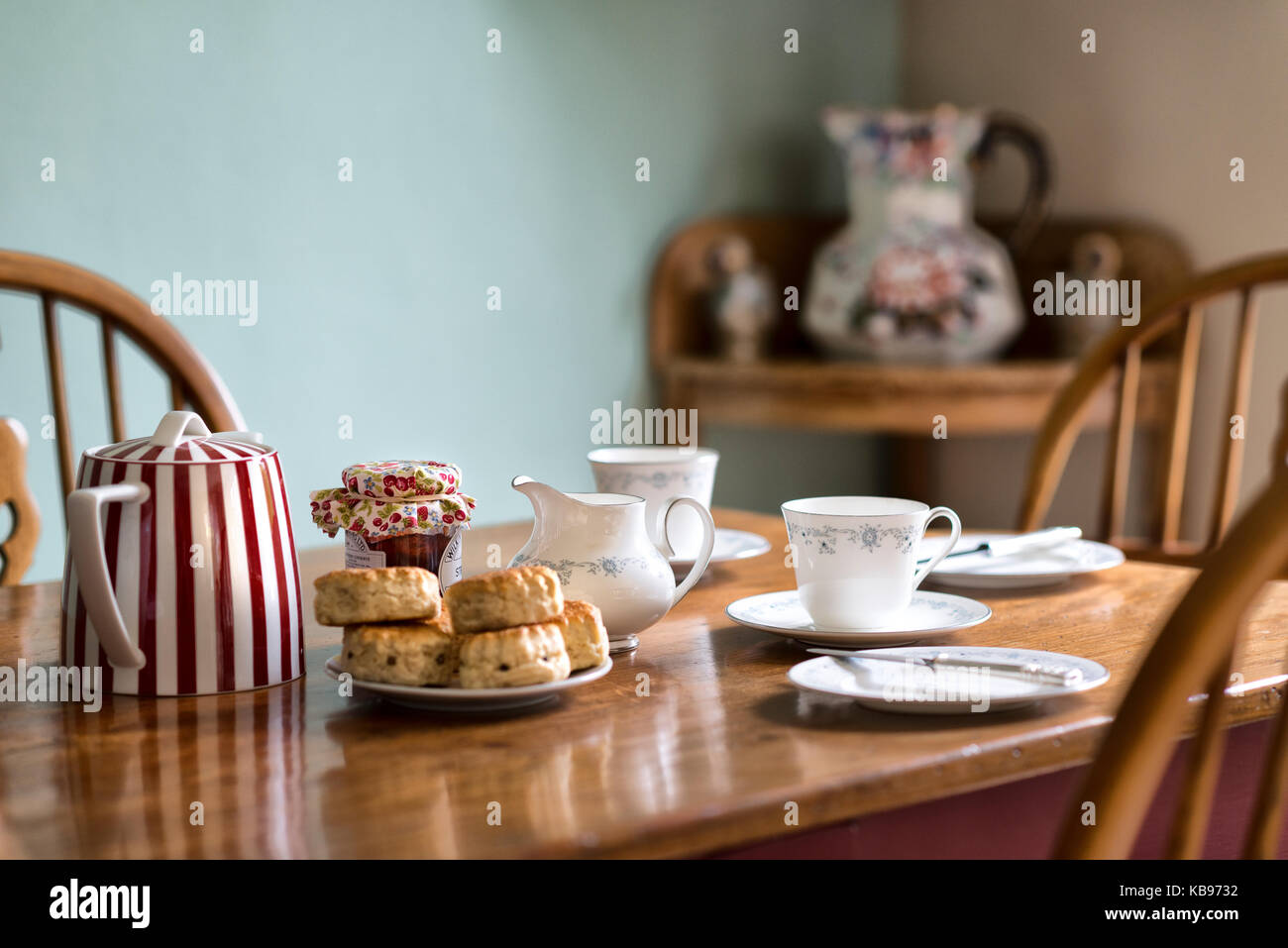 Traditional Devon cream tea in a farmhouse kitchen, with fruit scones ...