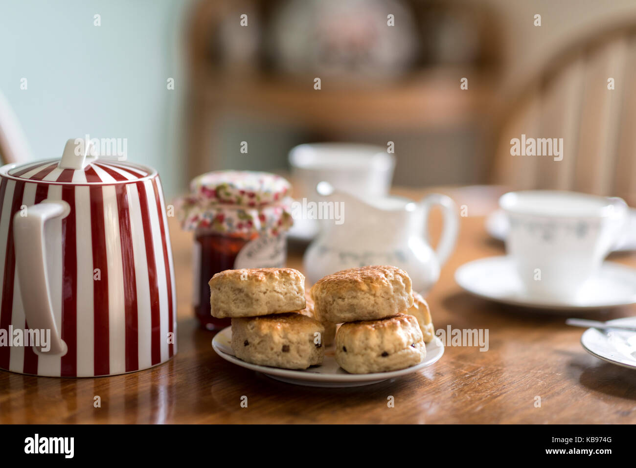 Traditional Devon cream tea in a farmhouse kitchen, with fruit scones ...