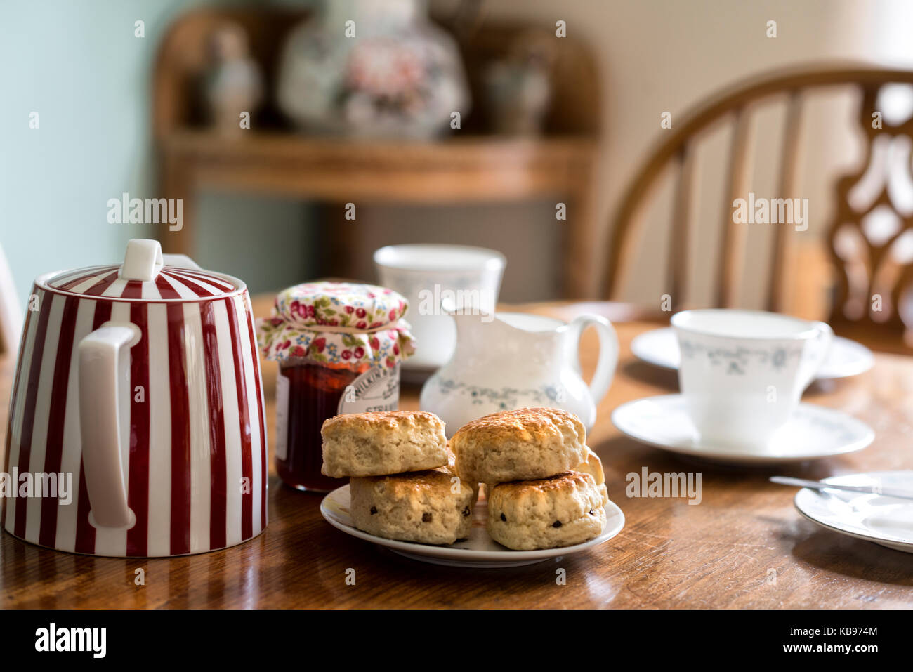 Traditional Devon cream tea in a farmhouse kitchen, with fruit scones ...