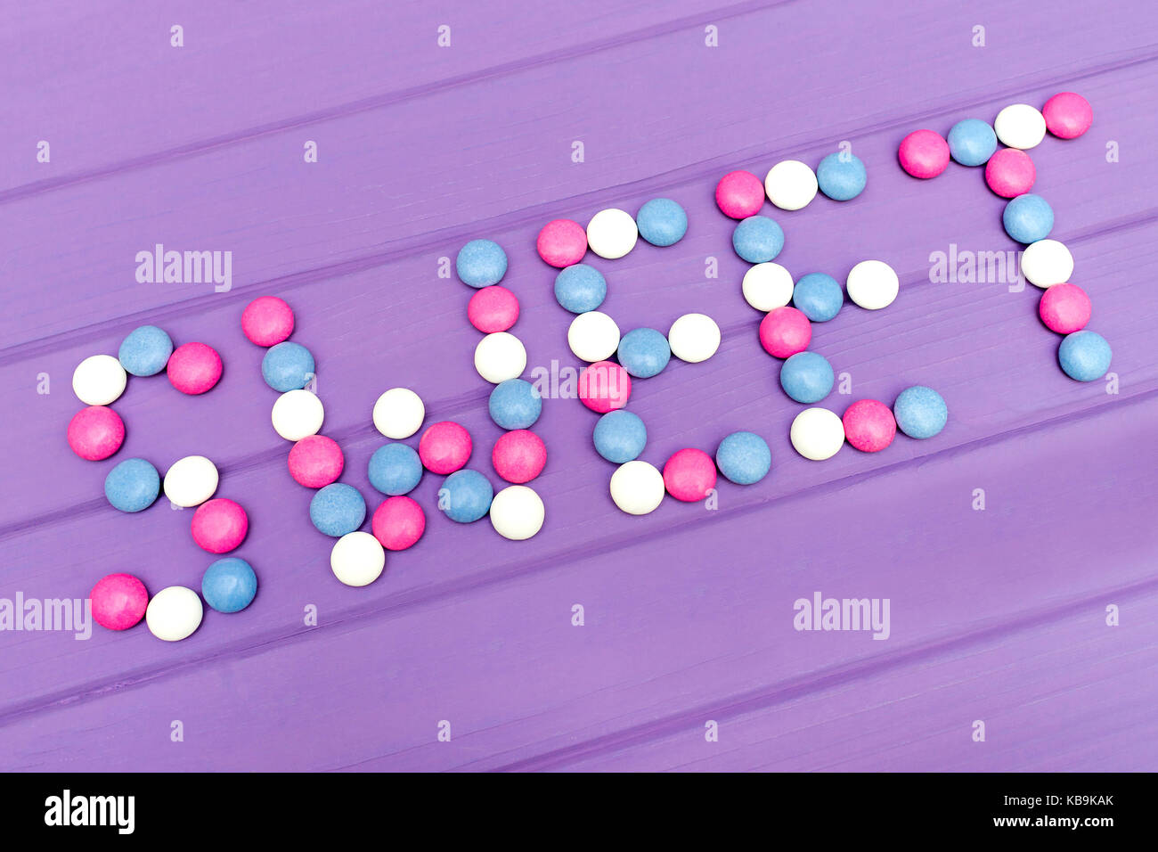 Image of word Sweet made of colorful candies on violet background Stock ...