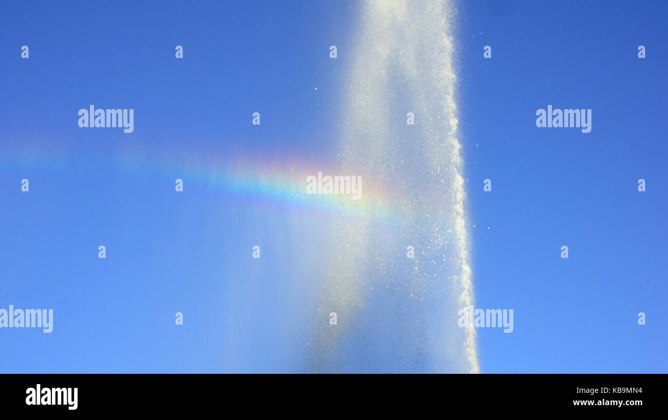 Rainbow stream of a fountain in the city square of Nalchik Stock Photo ...