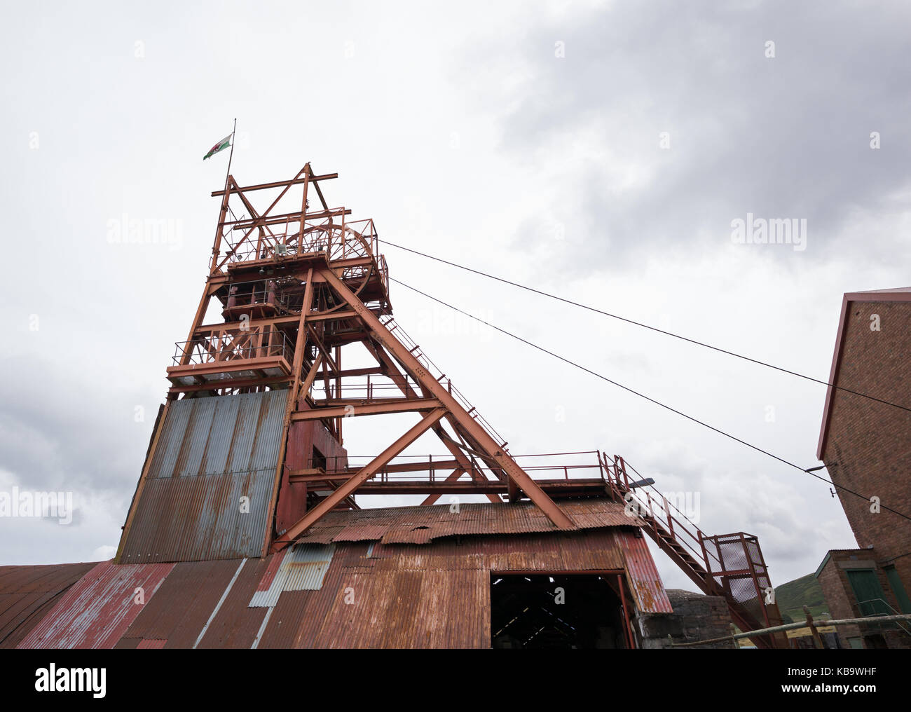 Winding gear of former colliery, with Welsh flag flying. Blaenavon, UK ...