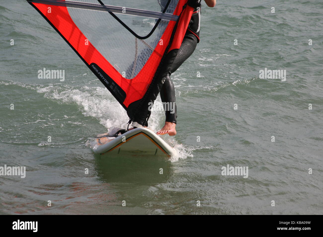 Surfer on surfboard with sail --- Surfer auf Surfboard mit Segel Stock ...