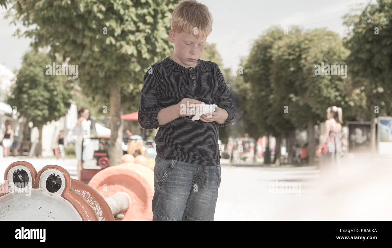 A confused boy on a city street Stock Photo - Alamy