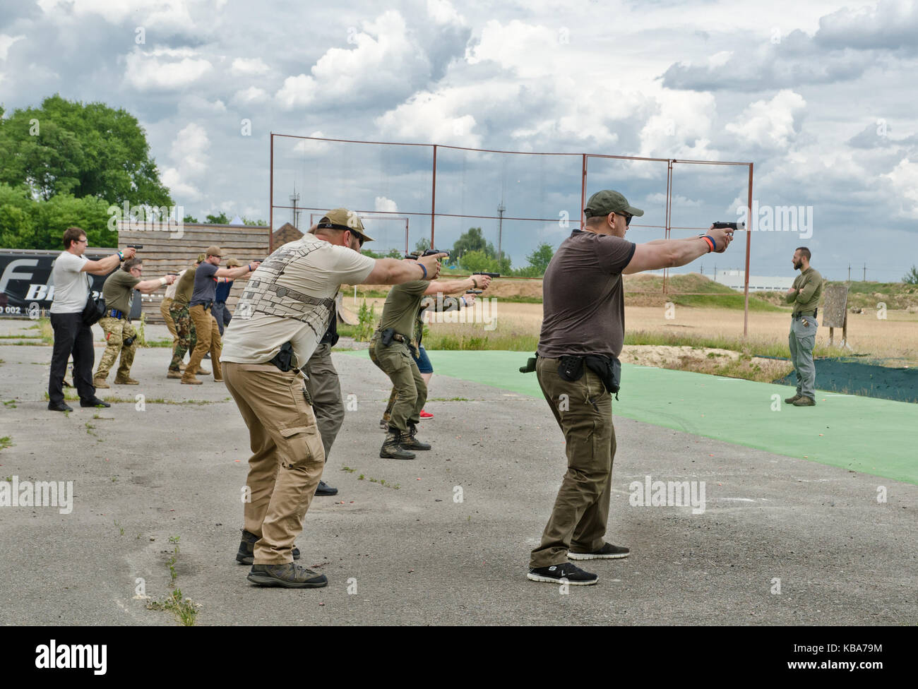 Men shooting outdoors Stock Photo - Alamy