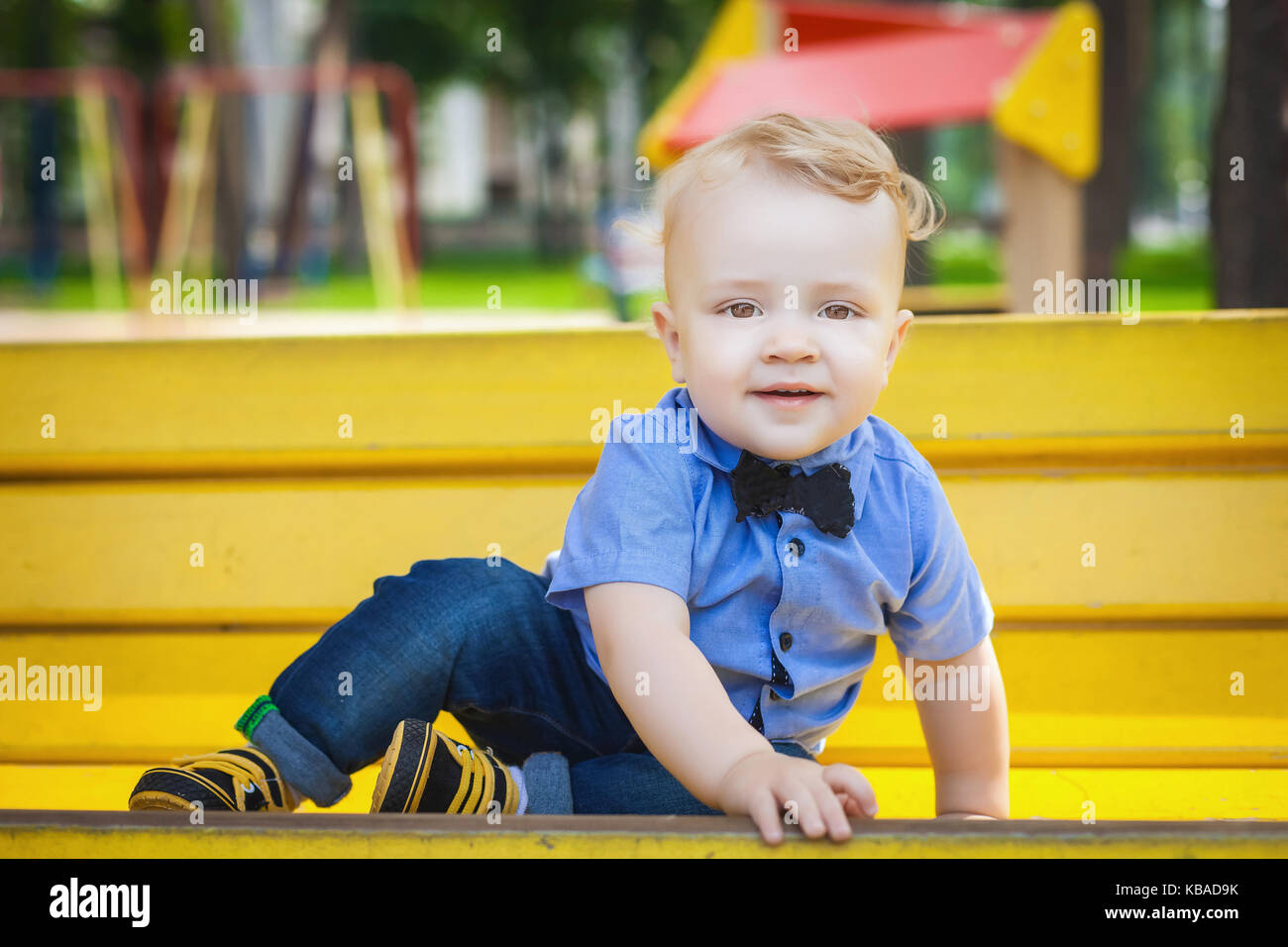 little boy sitting on bench Stock Photo - Alamy