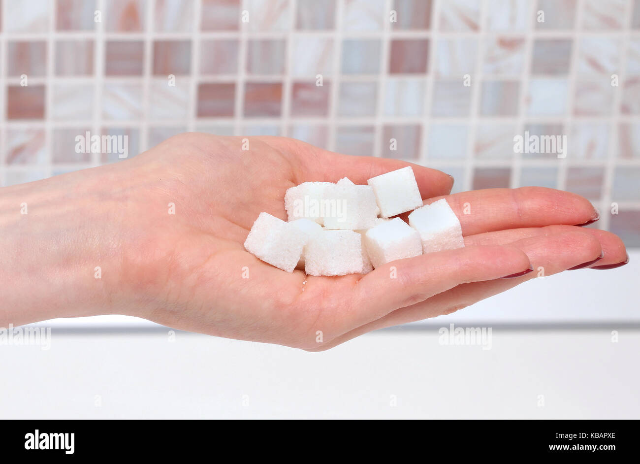 White sugar cubes pile in female hand Stock Photo - Alamy