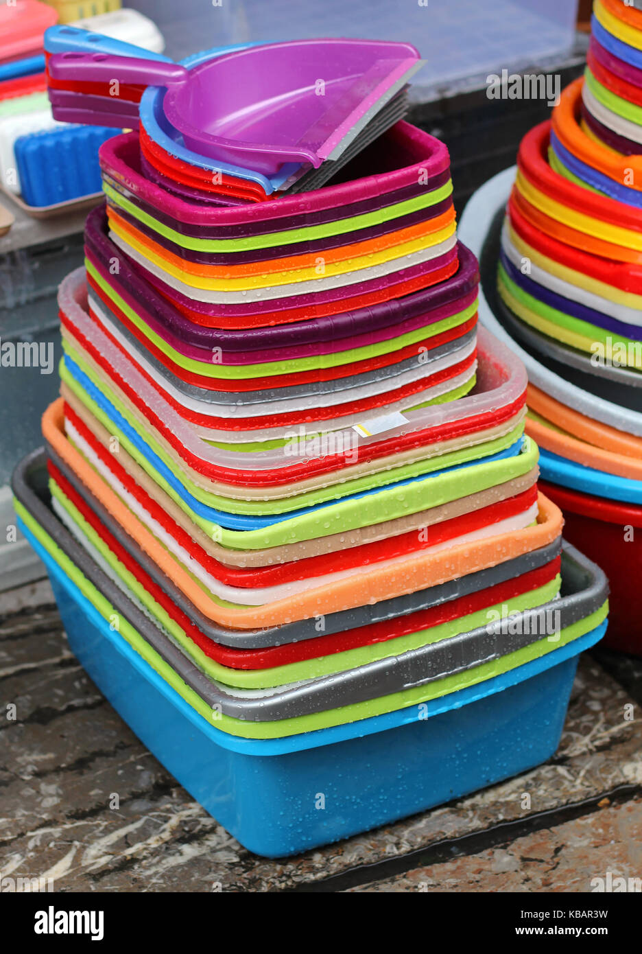 Colorful plastic bowls heap with rain drops Stock Photo - Alamy
