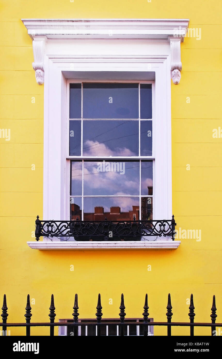 Vintage window on retro yellow house facade Stock Photo - Alamy