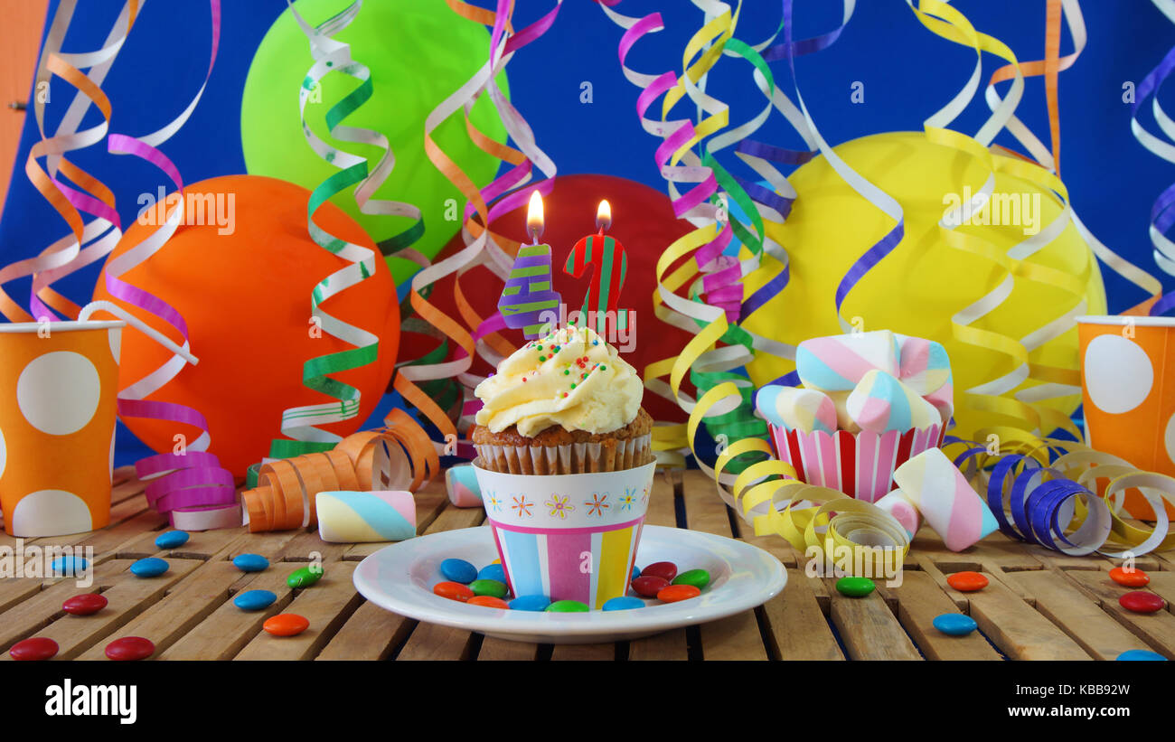 42 Birthday cupcake with candles burning on rustic wooden table with ...