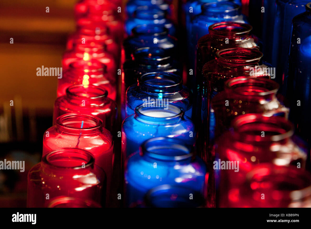group of colored candles in red and blue glass container Stock Photo ...