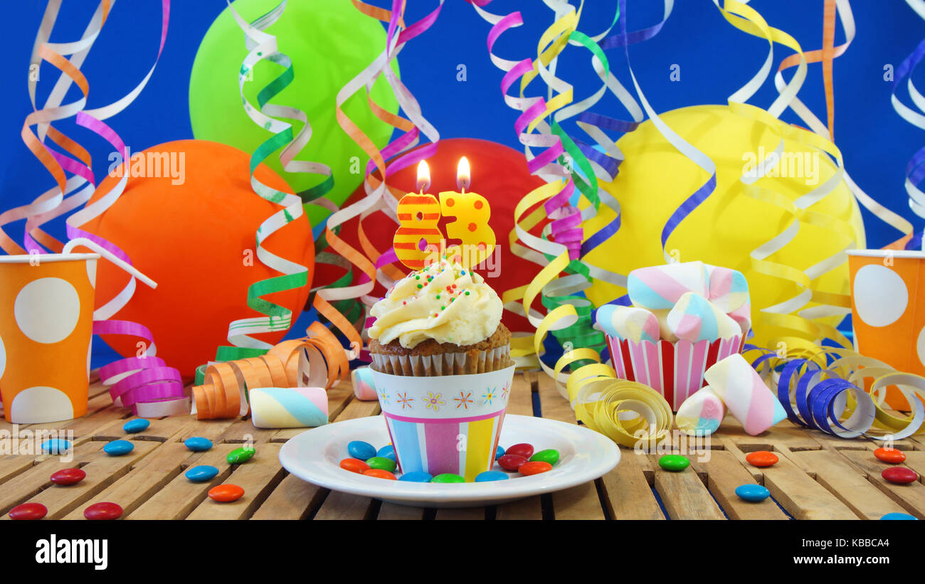 83 Birthday cupcake with candles burning on rustic wooden table with ...